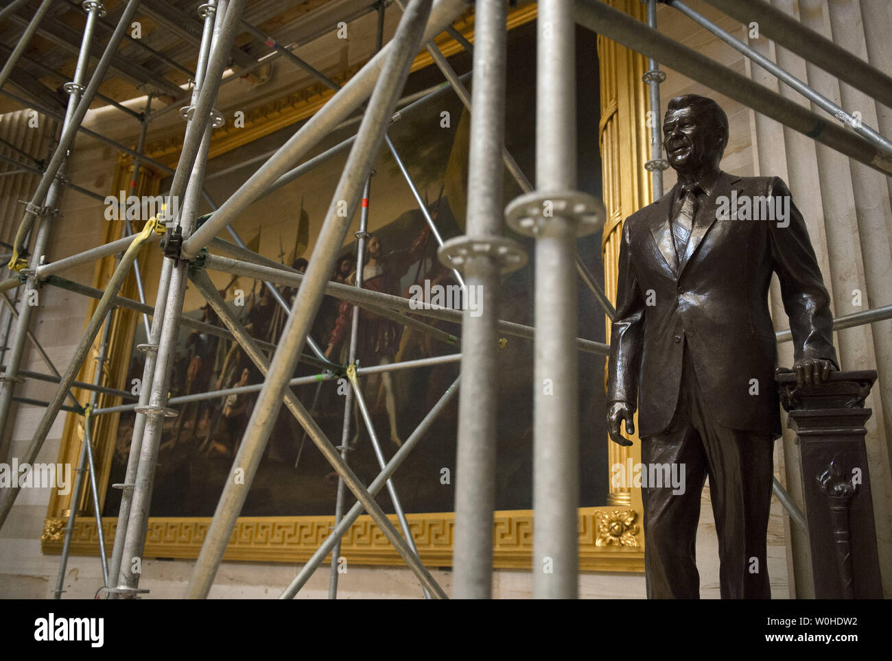 A statue of President Ronald Reagan is seen surrounded by scaffolding ...