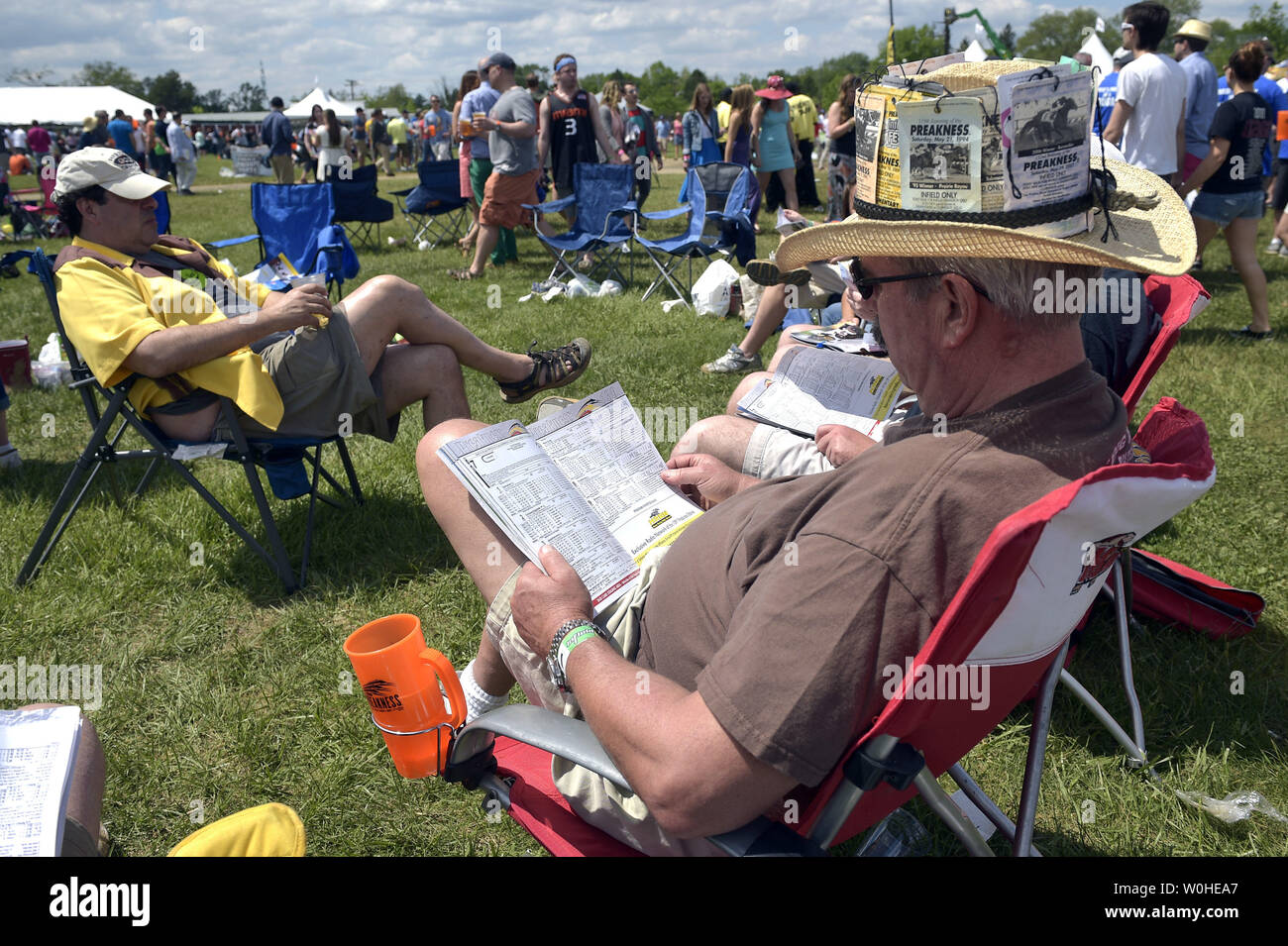 A man reads a program in the infield at the 139th running of the ...
