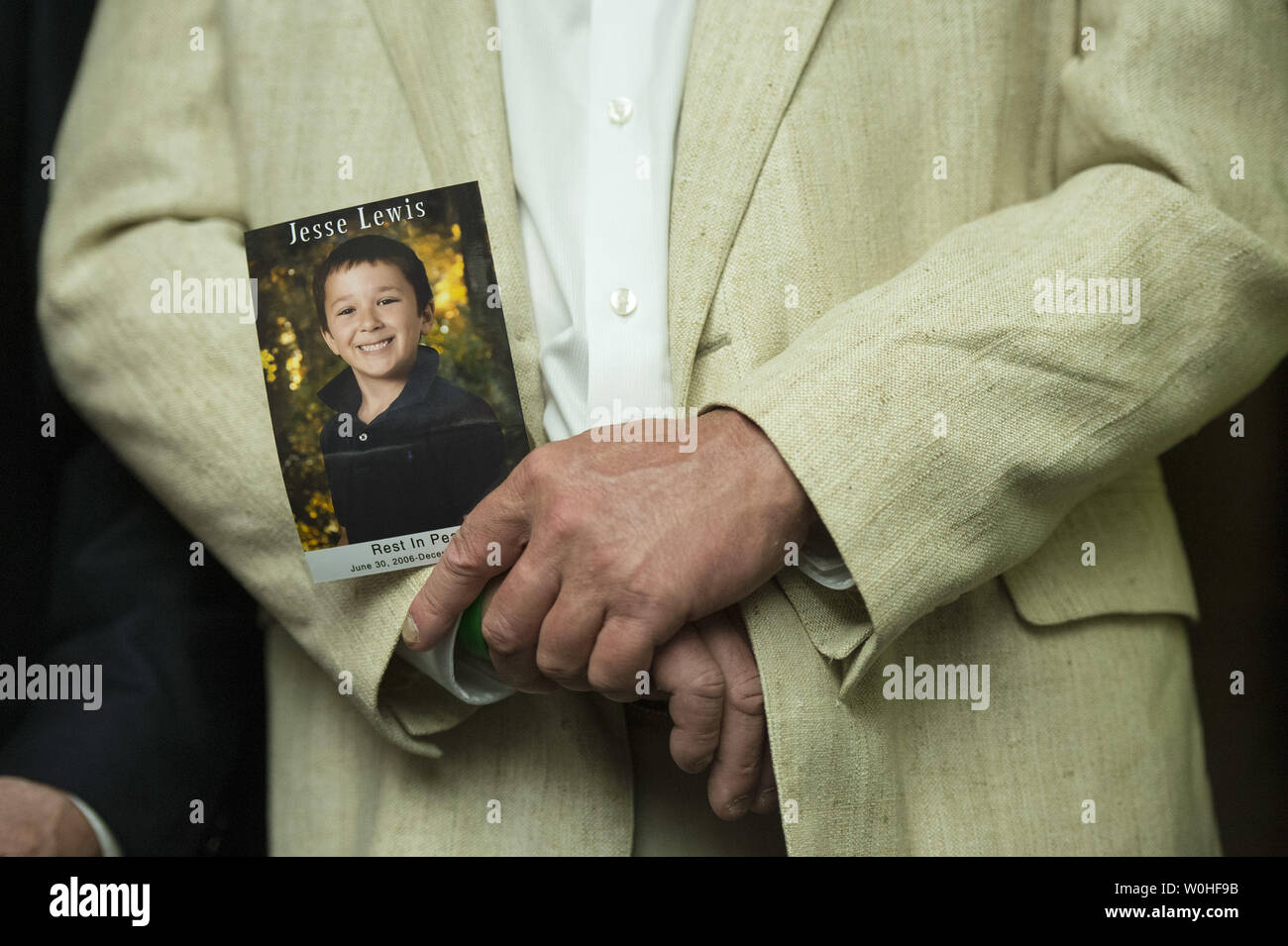 Neil Heslin holds a photo of his son Jesse Lewis, 6, who was killed ...