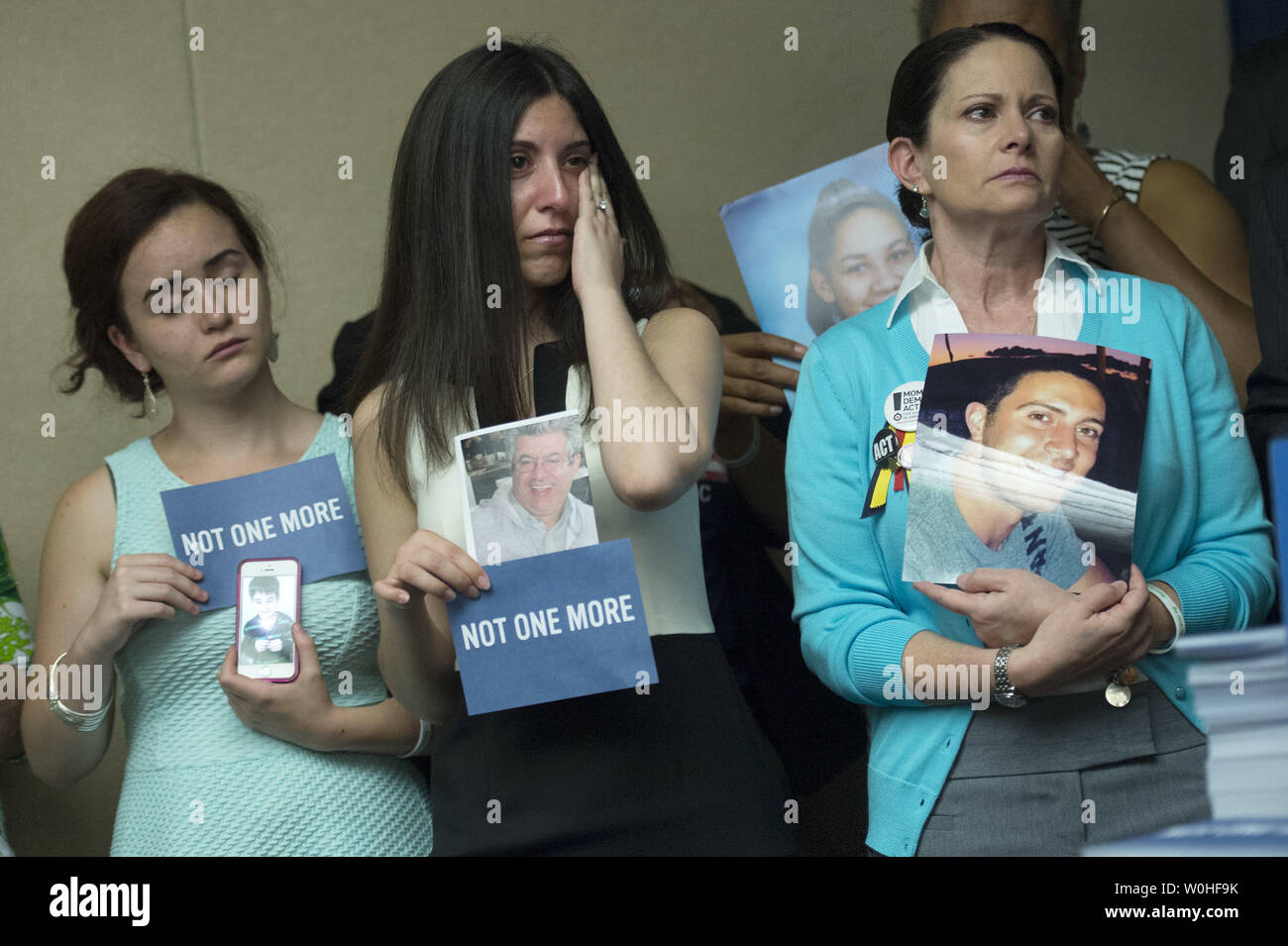 From left to right, Danielle Vabner, holding a photo of Noah Pozner who ...