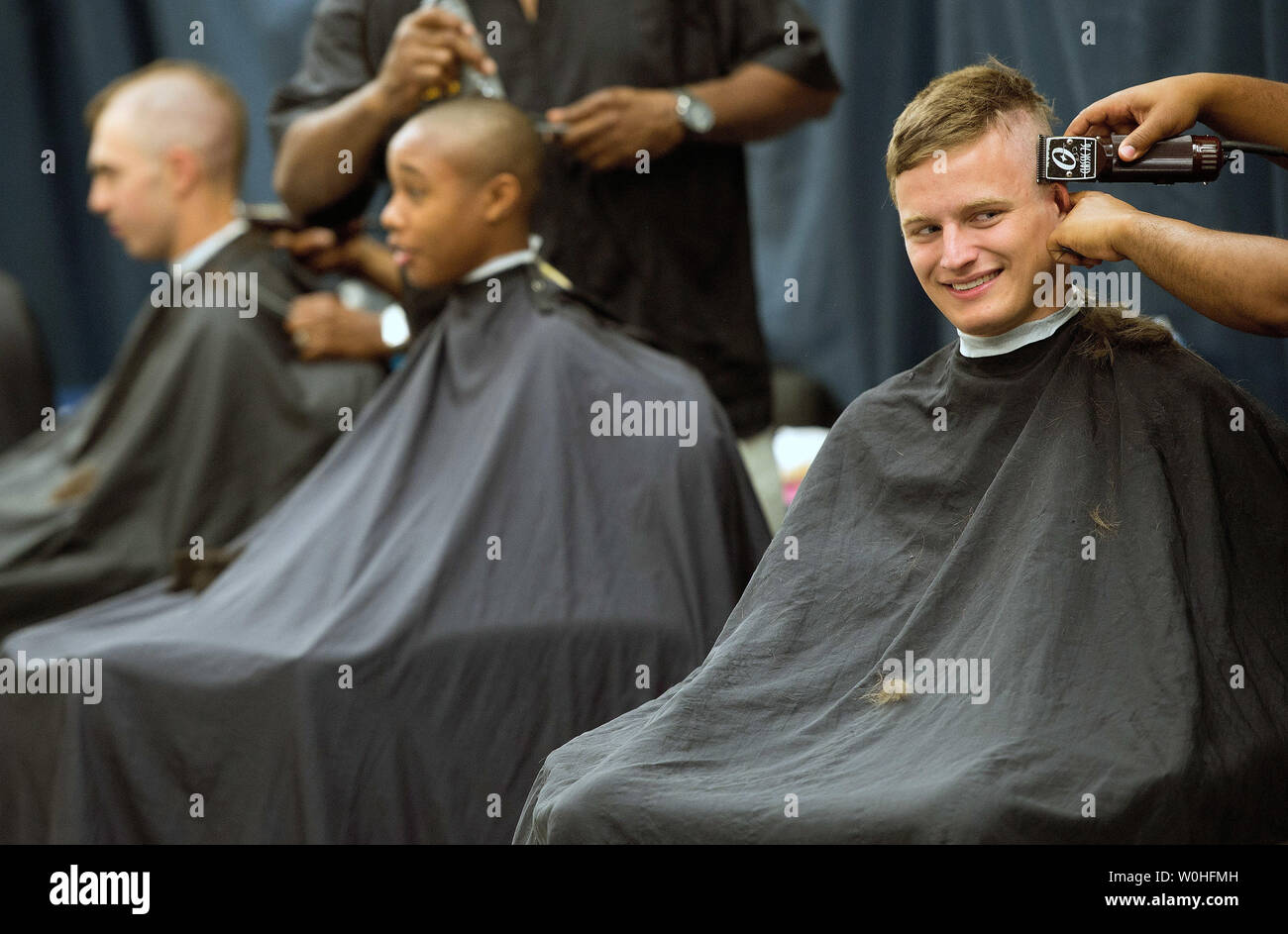 Incoming Plebes have their heads shaved on Induction Day at the U.S ...