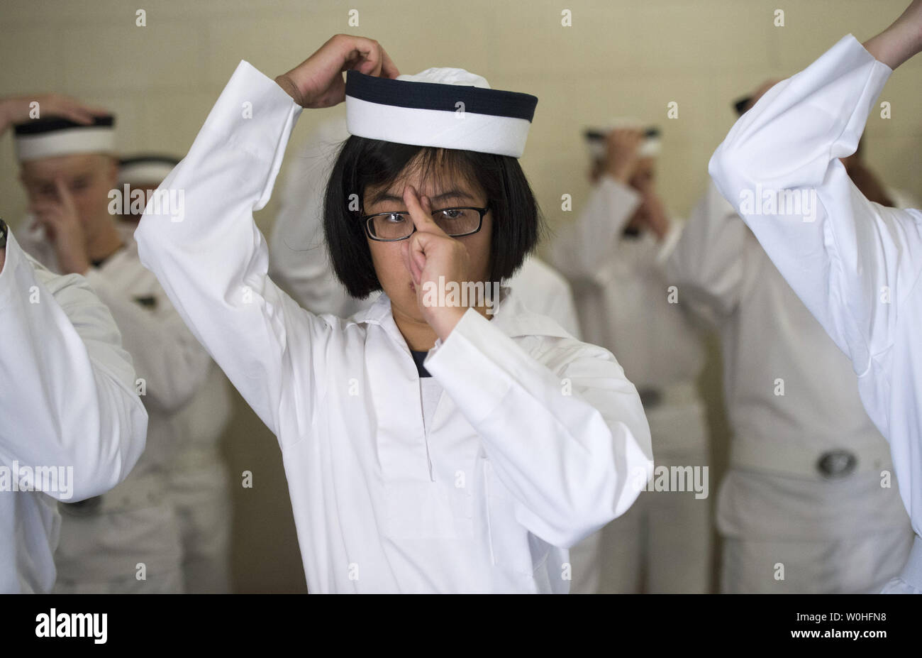 A Plebe learns to salute during Induction Day at the U.S. Naval Academy ...