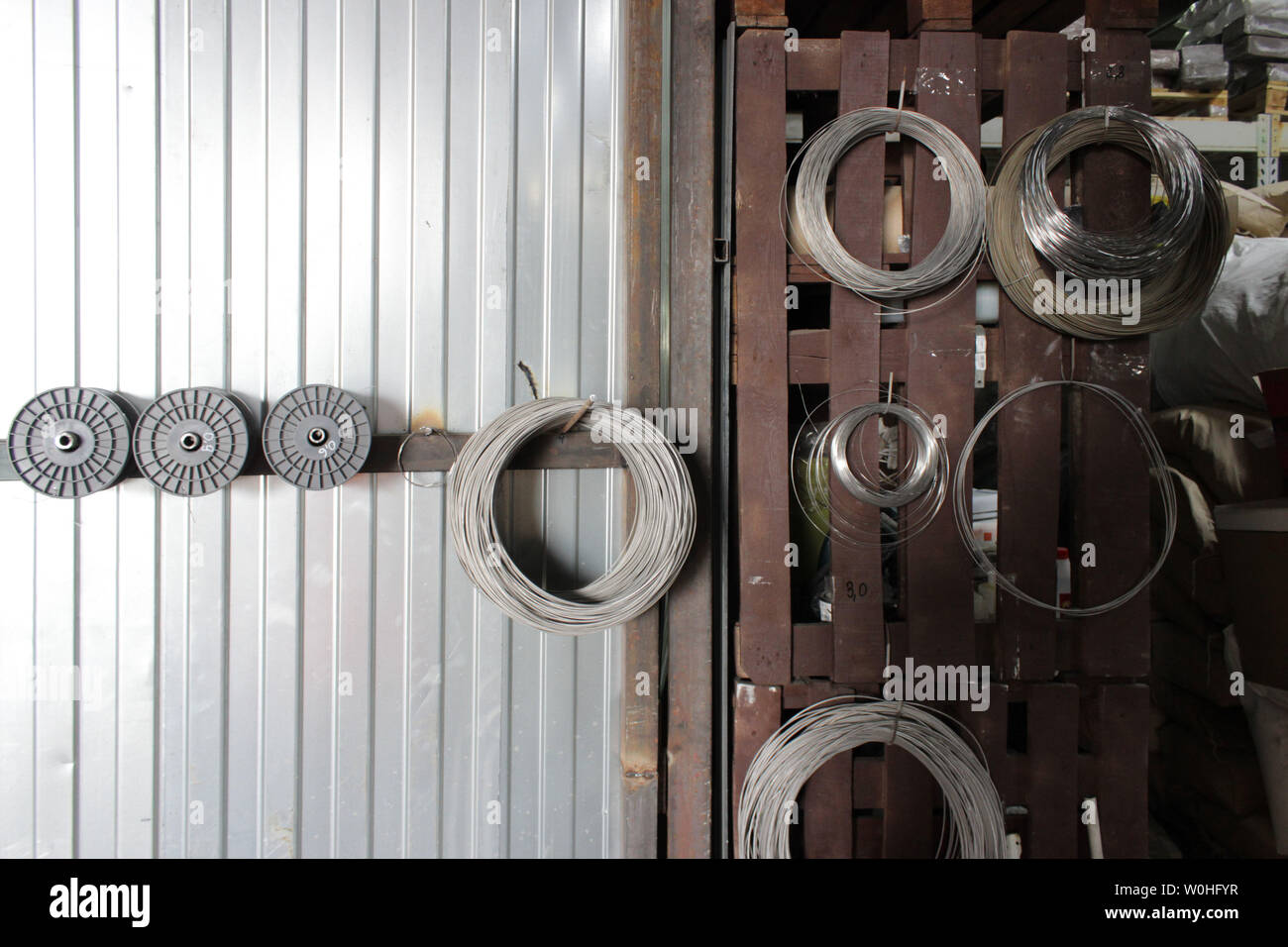 some coils of fechral thick refractory wire hangs in a warehouse of ...