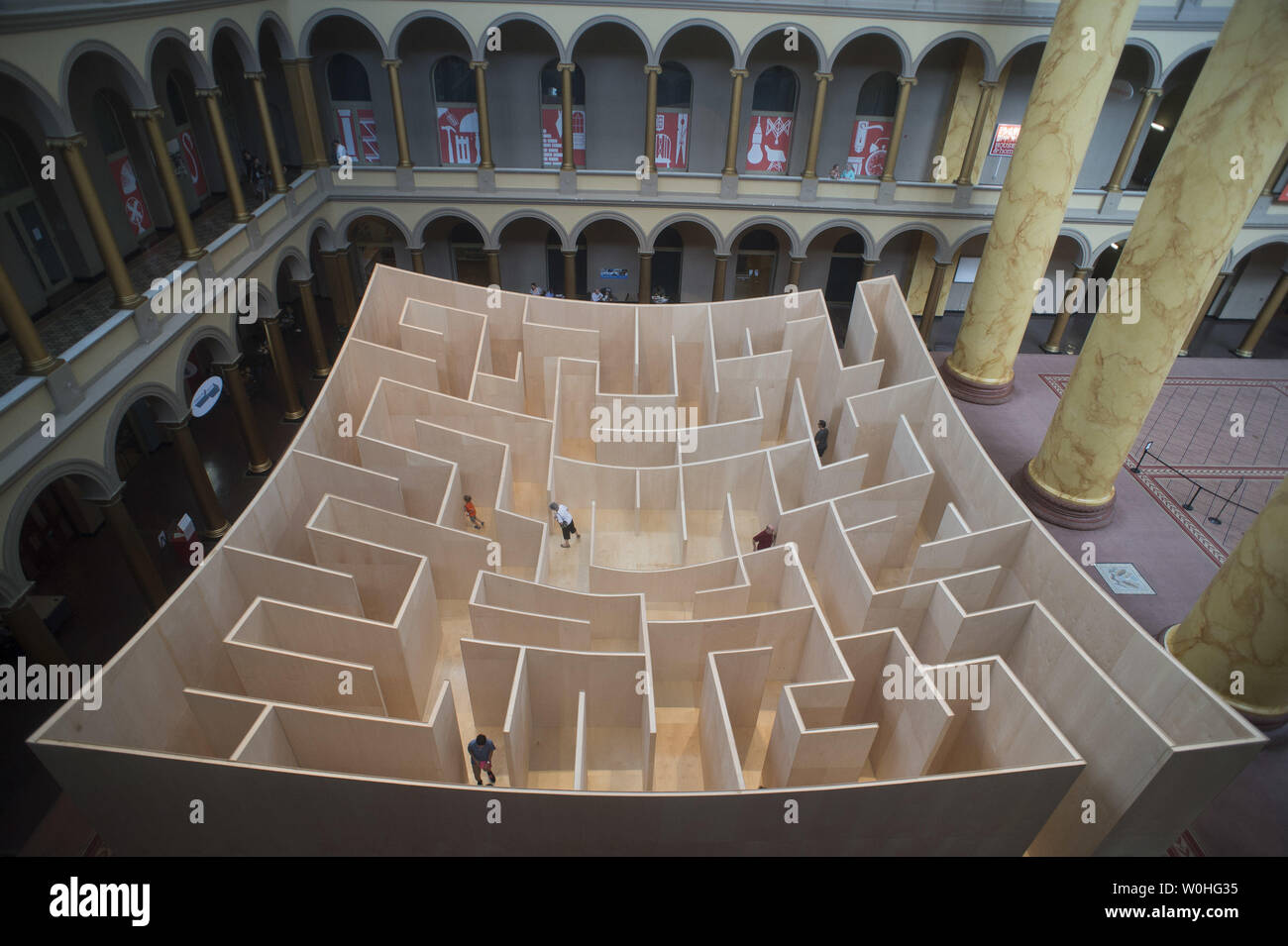 Visitors navigate the Big Maze at the National Building Museum in ...