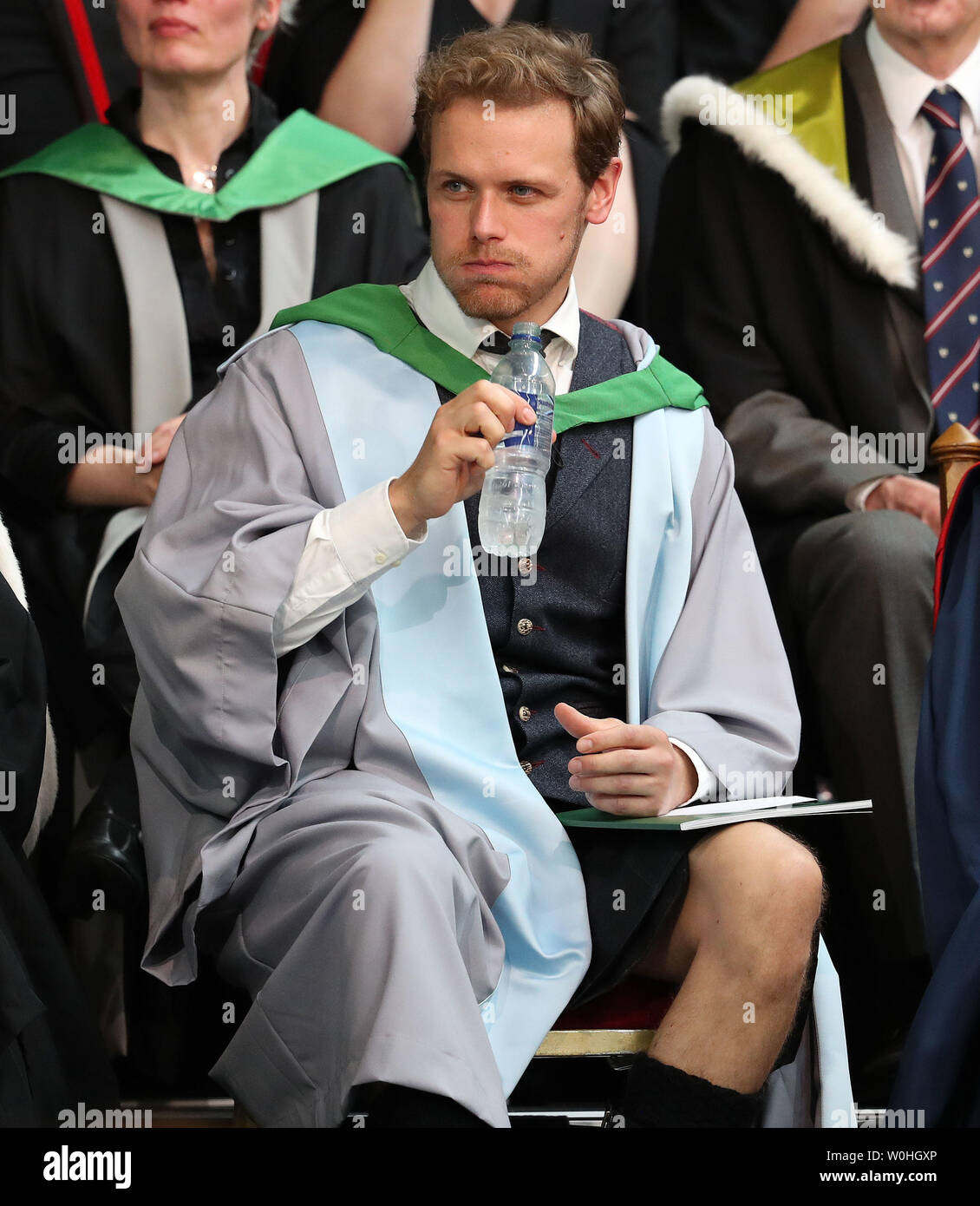 Outlander actor Sam Heughan drinks some water after receiving his ...