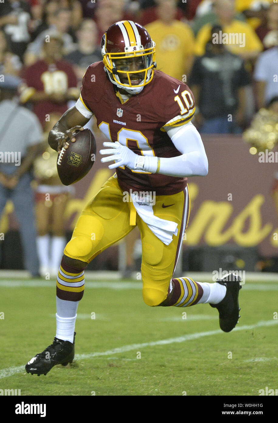 Washington Redskins quarterback Robert Griffin III (10) runs against ...
