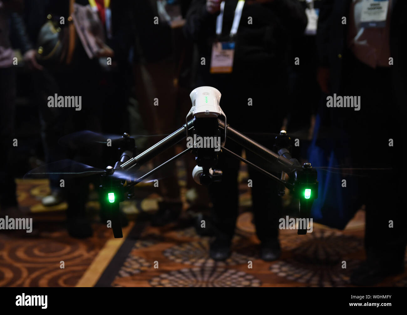 Members of the media view the DJI Inspire 1 flying platform during CES ...