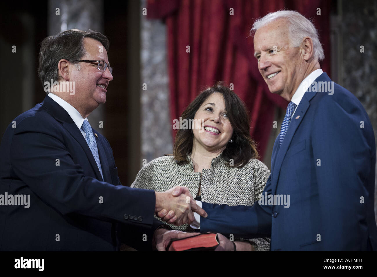 Vice President Joe Biden (right) administers the Senate oath to Senator Gary Peters (R-MI) as ...