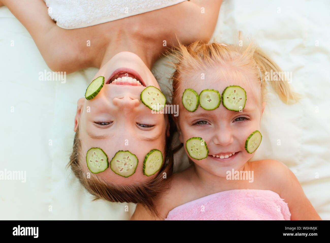 Beautiful girl with facial mask of cucumber Stock Photo - Alamy