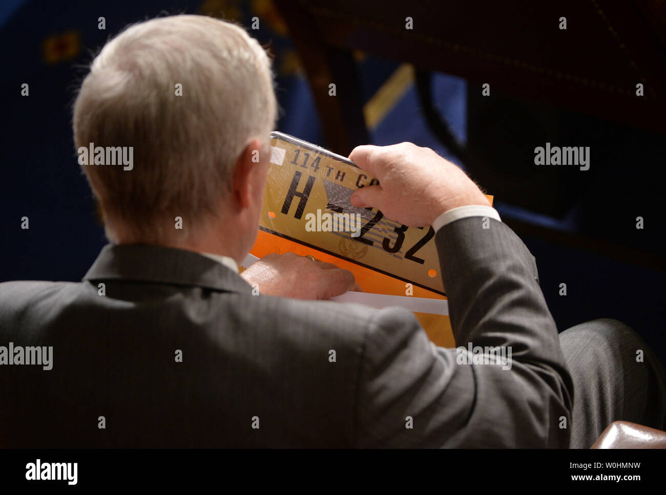 A new Congressman looks at his license plate on the first day of the ...