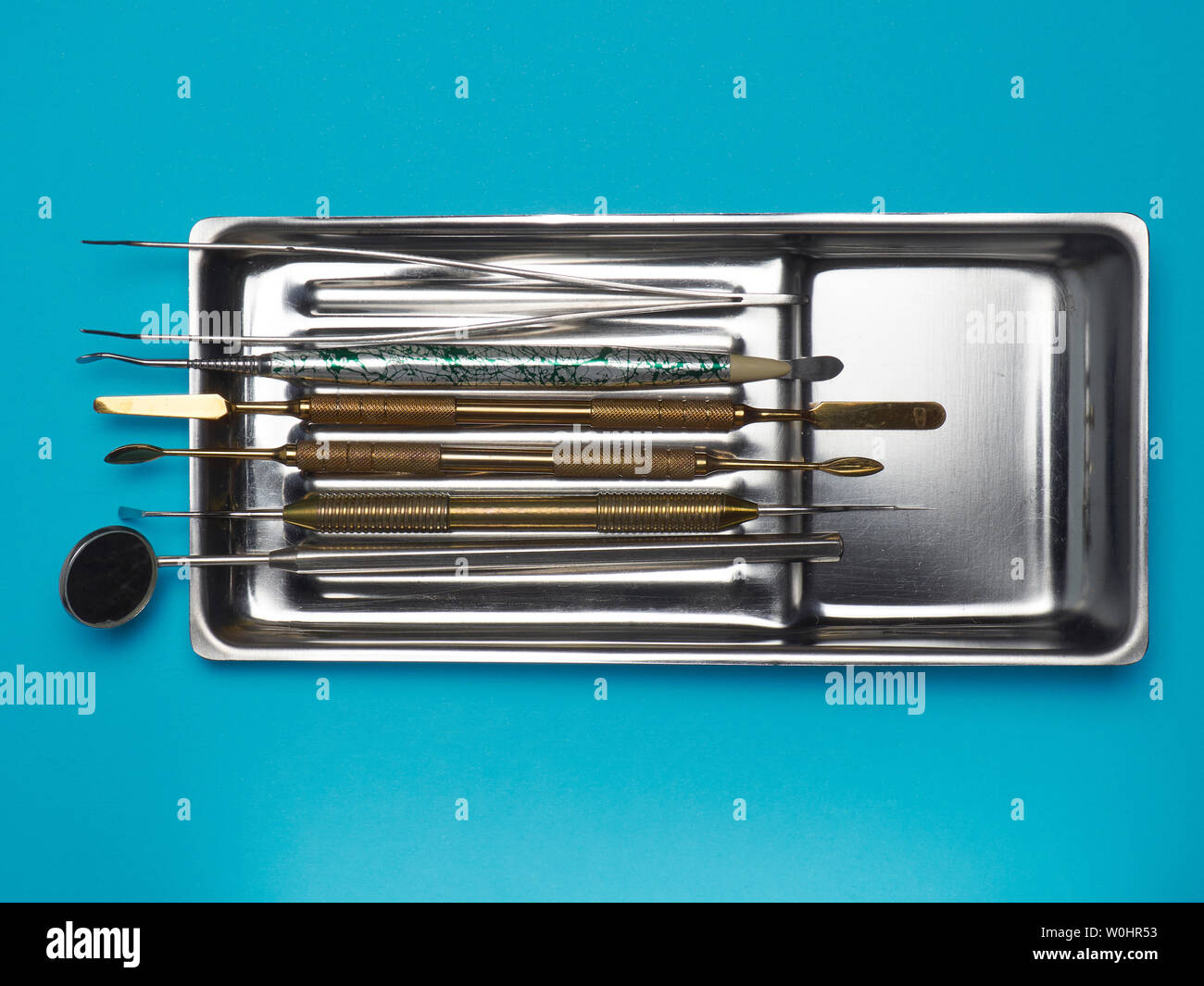 Dental tools in the tray on blue background. Dental health concept ...