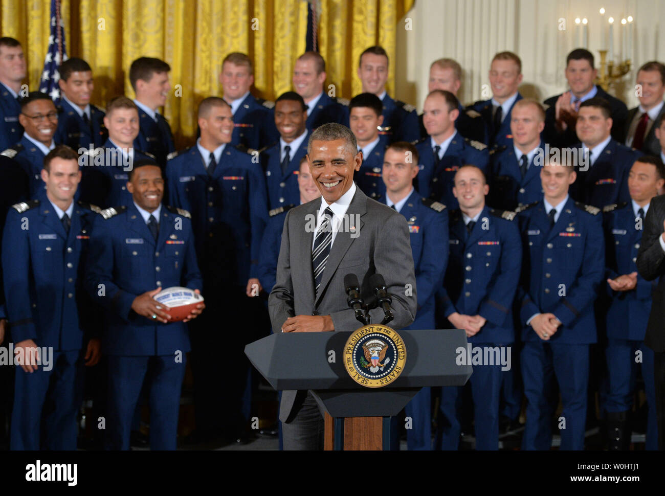 President Barack Obama presents the Commander-in-Chief Trophy to the ...
