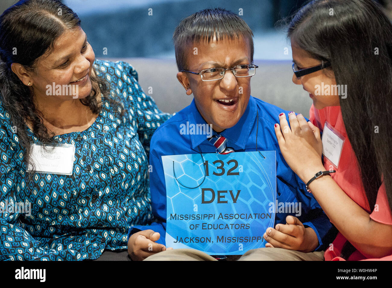 Dev Jaiswal, 13, of Jackson, Mississippi, is comforted by his family ...