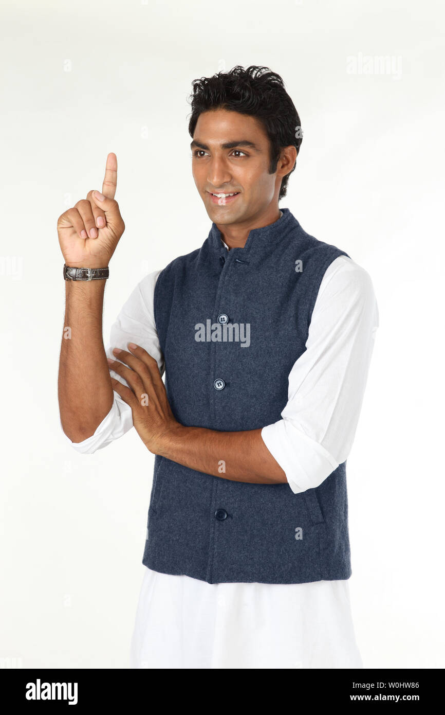 Indian young man pointing upward Stock Photo - Alamy
