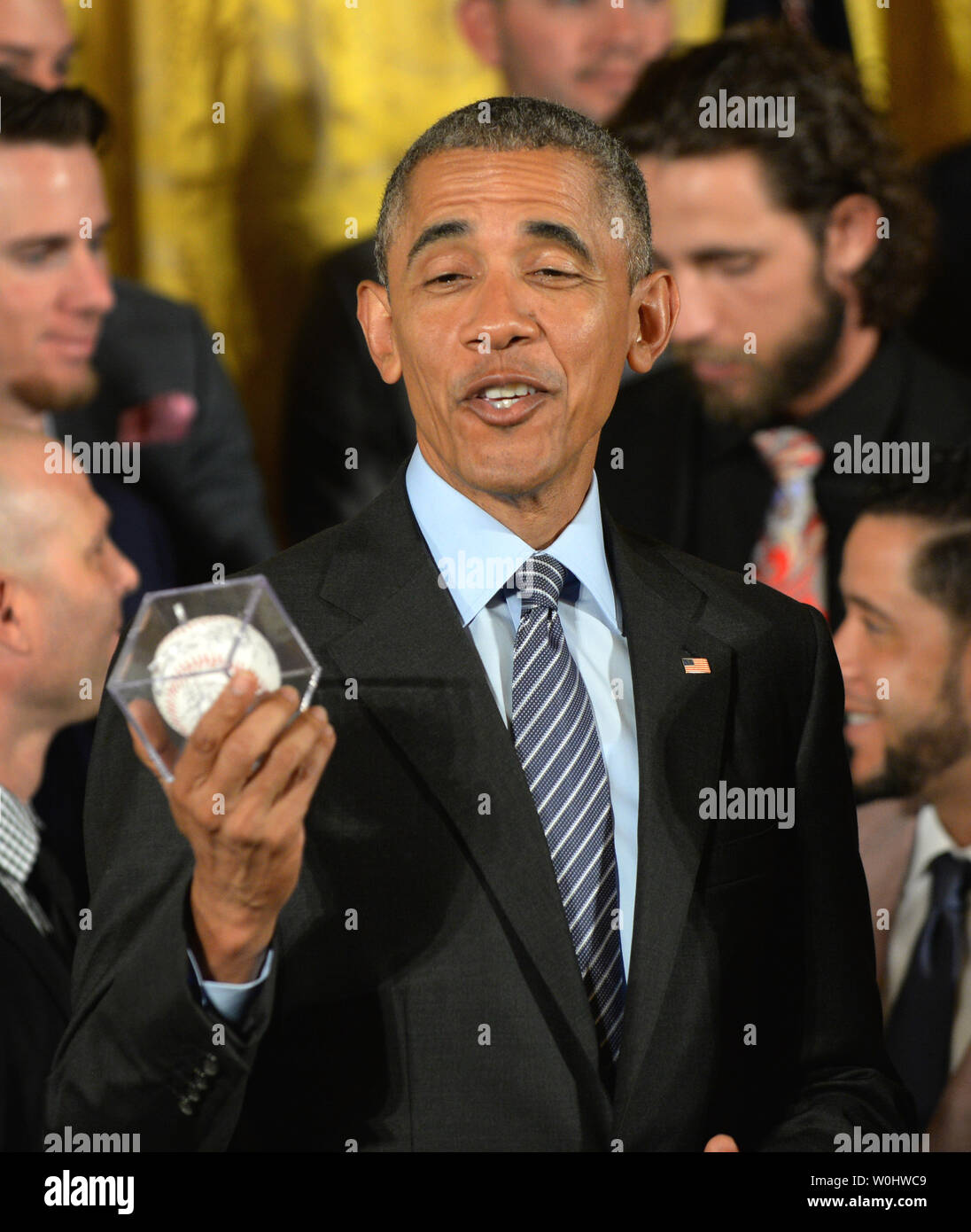 U.S President Barack Obama shows the team ball given to him by San ...