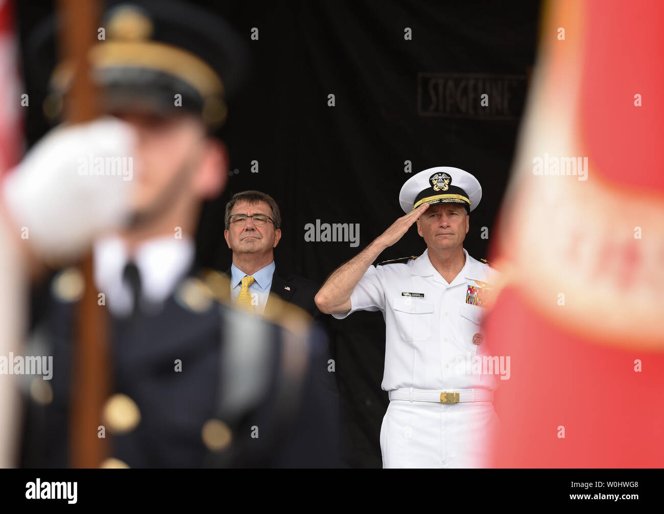 Defense Secretary Ash Carter stands next to Admiral Sandy Winnefeld ...