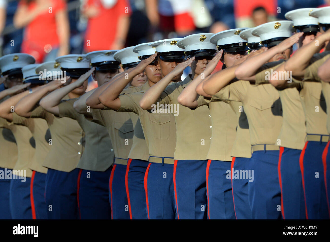 Members of the U.S. Marine Corps. salute for the National Anthem prior ...