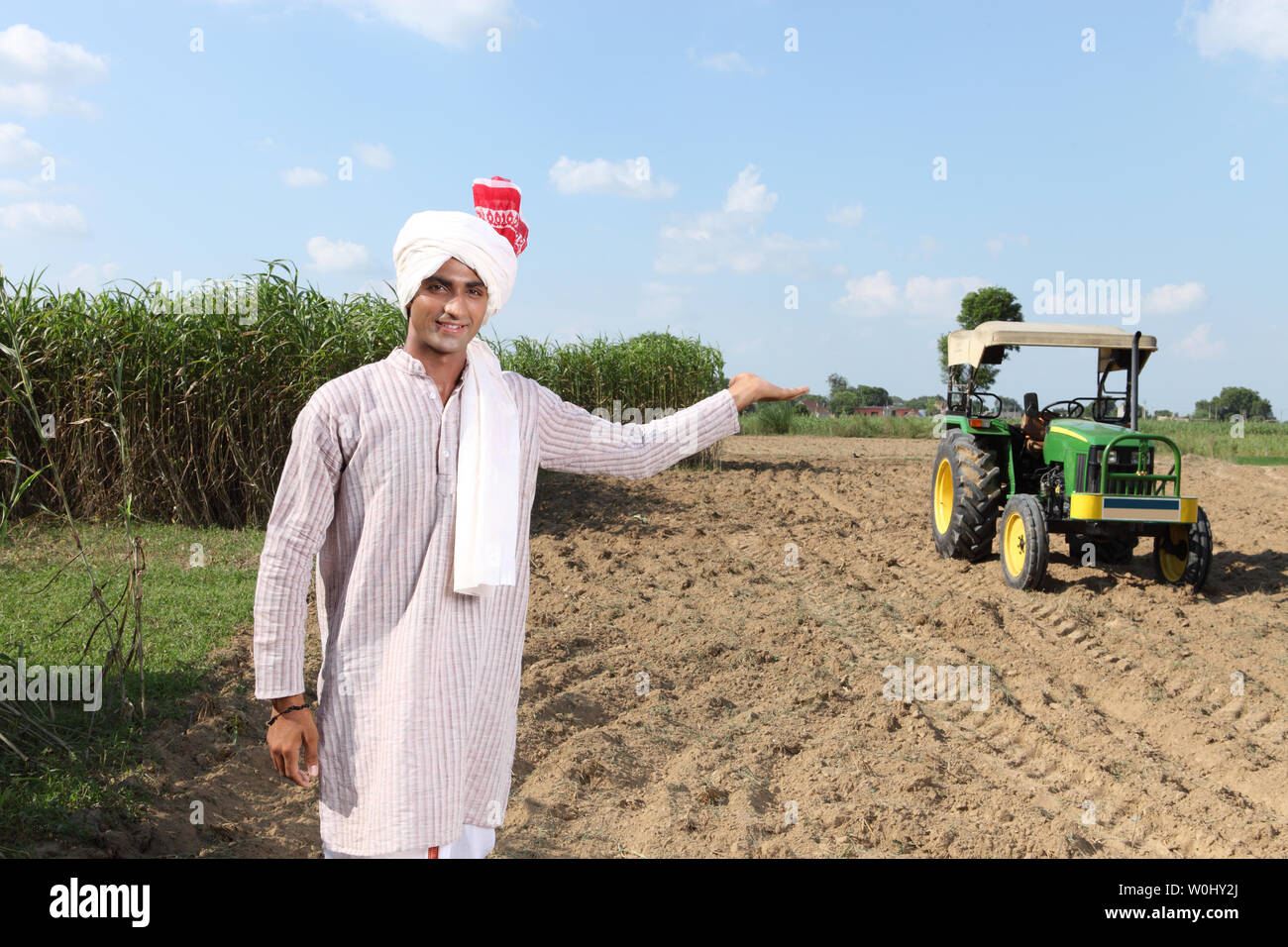 Portrait of a farmer showing his field Stock Photo - Alamy