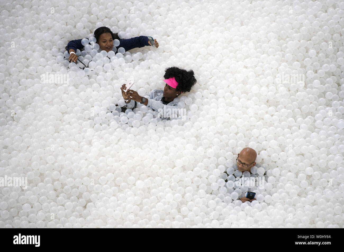 Visitors play in a pit of balls at the BEACH exhibit at the National ...