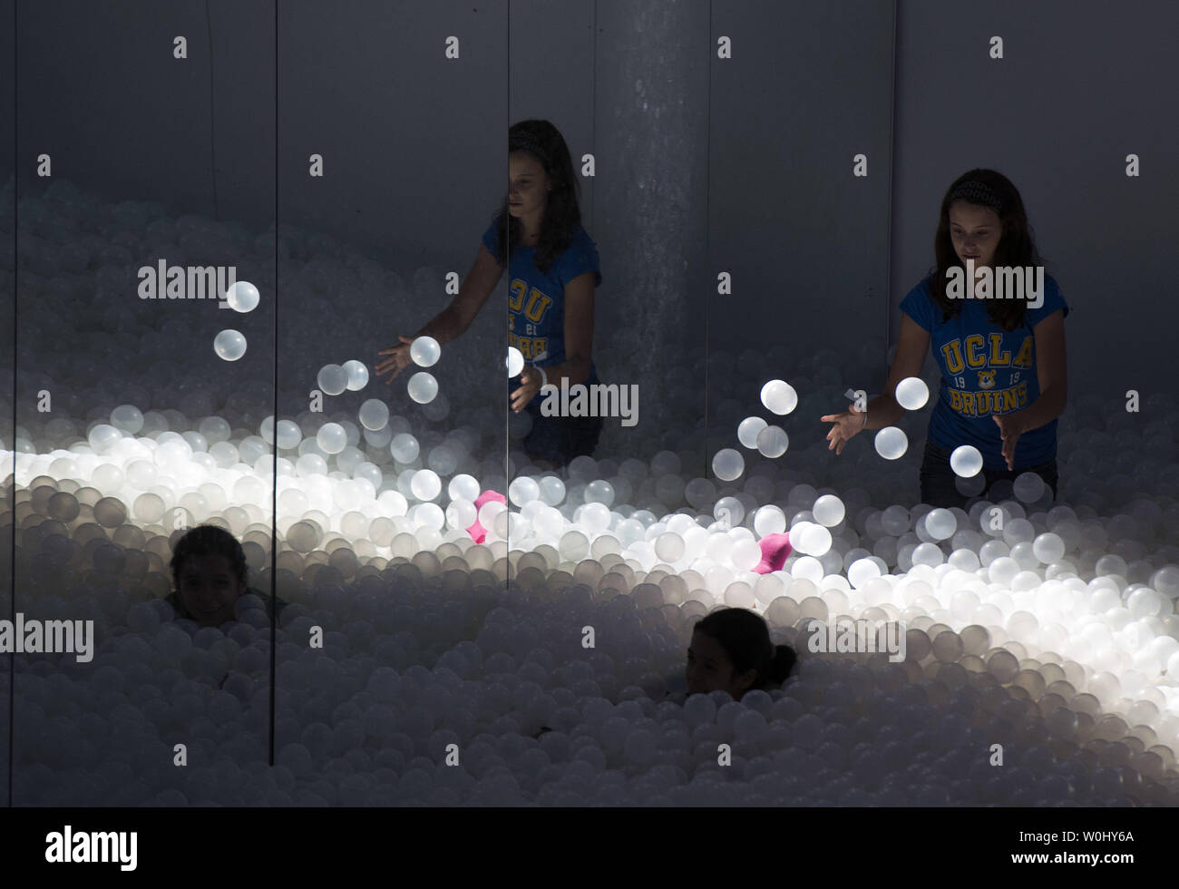Visitors play in a pit of balls at the BEACH exhibit at the National ...