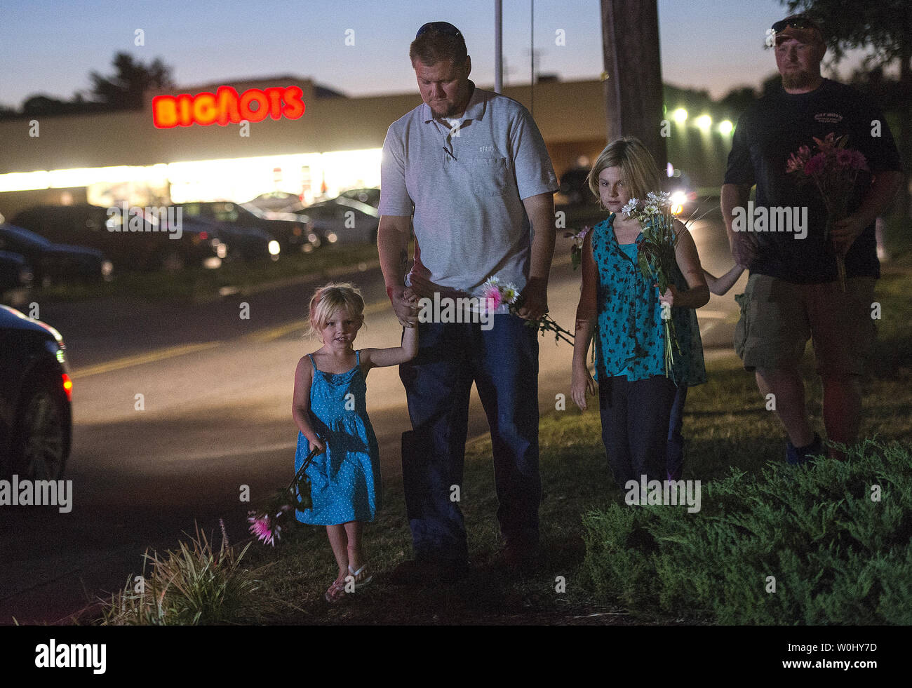 Mourners arrive to leave flowers at a memorial at the WDBJ-TV station ...