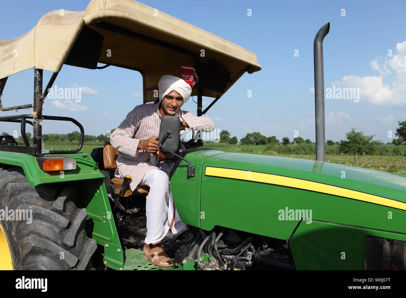 Young man sitting on tractor hi-res stock photography and images - Alamy