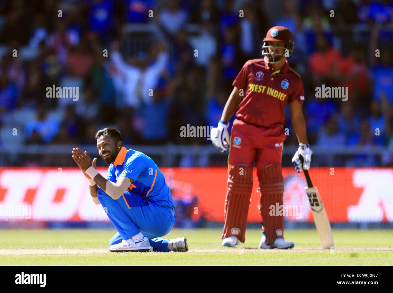 India's Hardik Pandya (left) celebrates taking the wicket of West ...
