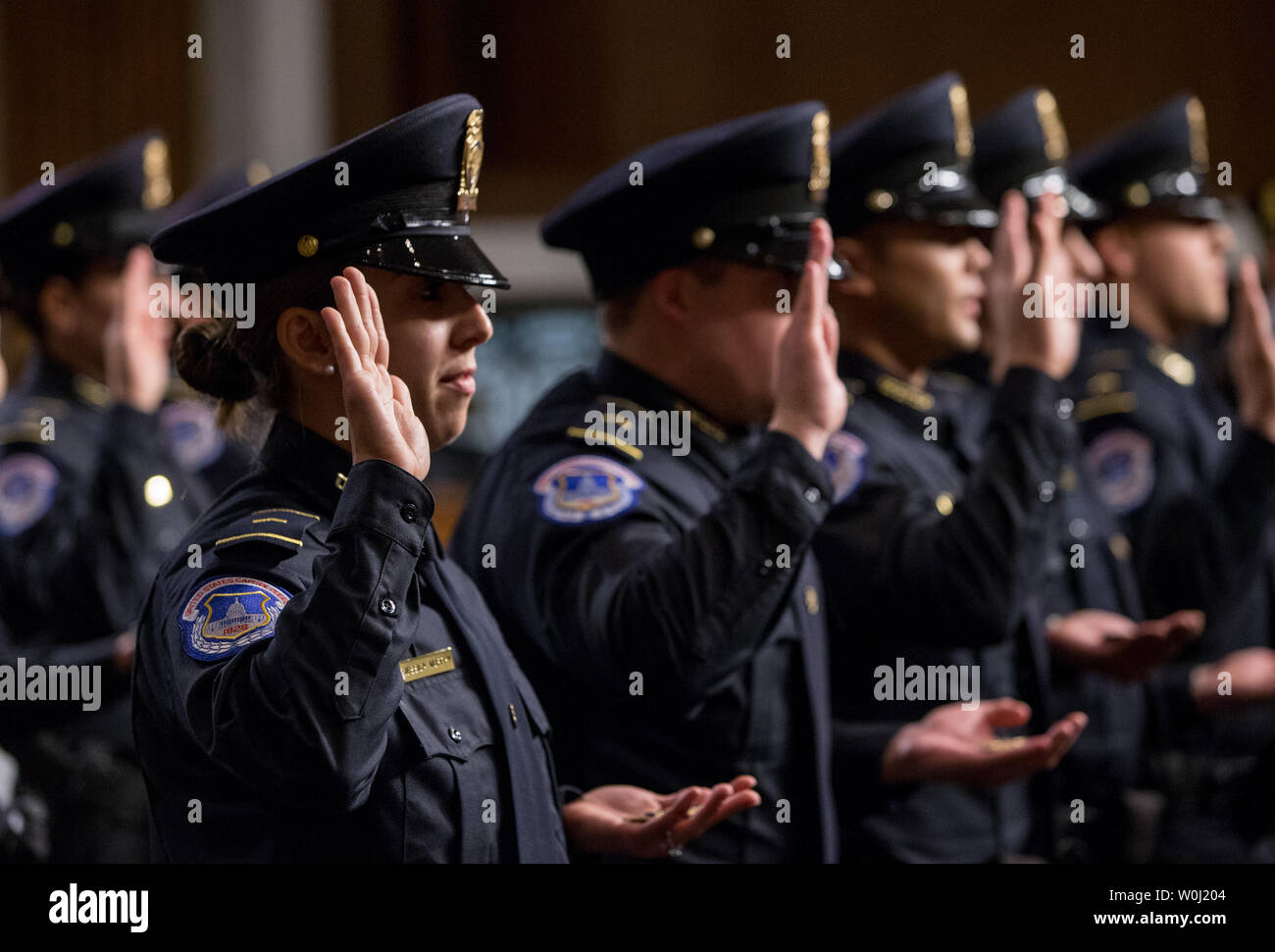 The 22 officers of the Recruit Officer Class 180 take the oath during ...