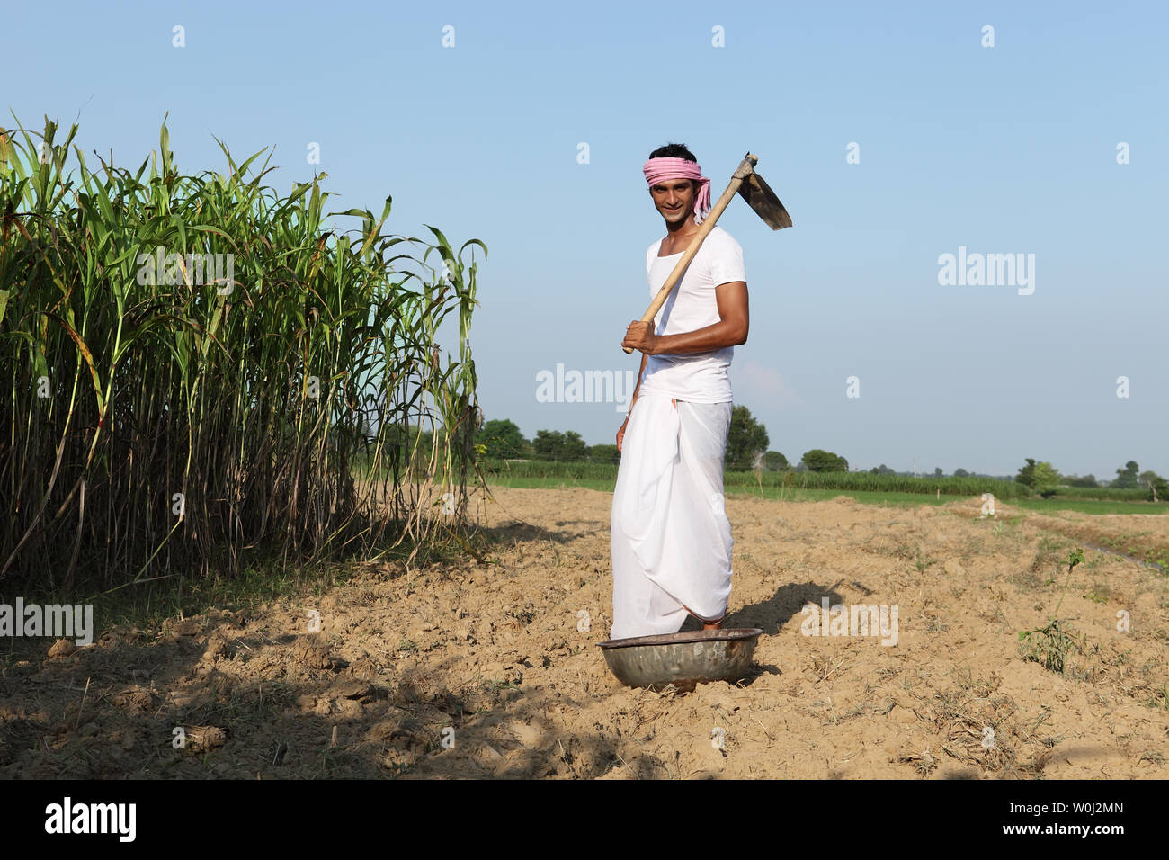 Farmer working in a field Stock Photo - Alamy
