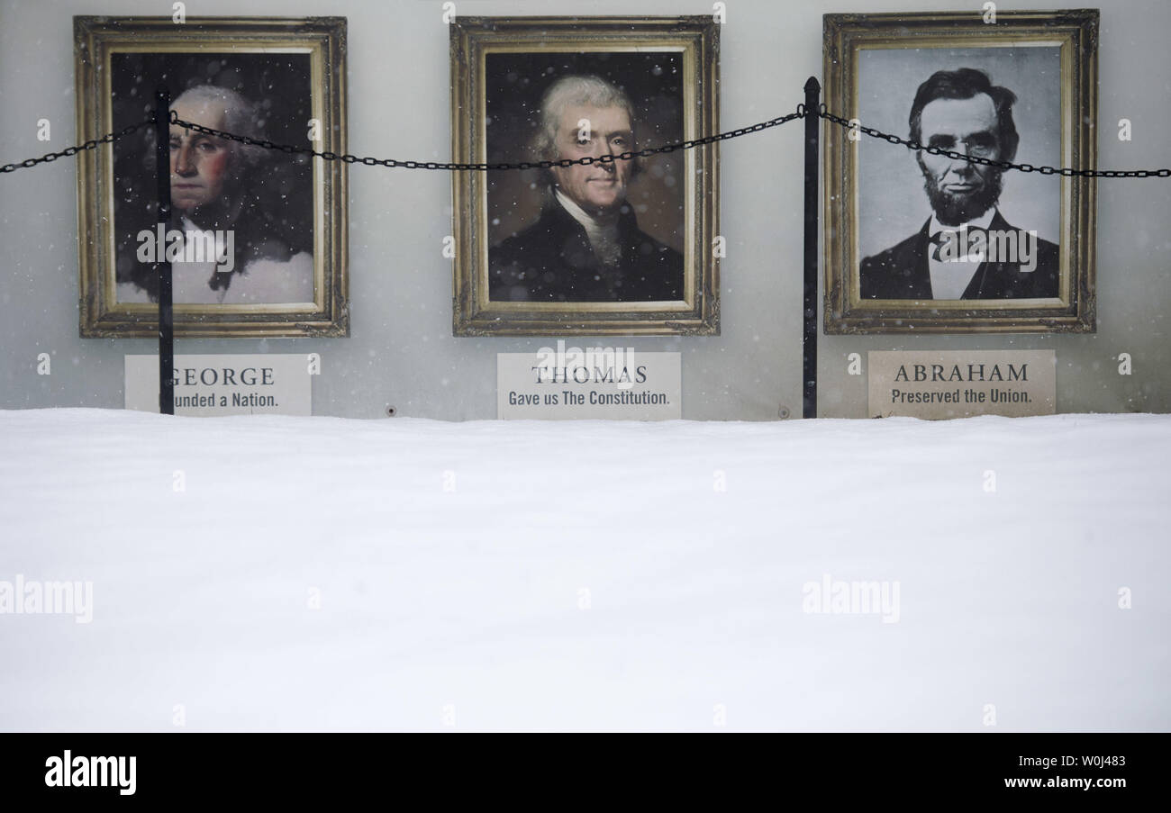 Portraits of Presidents are seen as snow falls near the Lincoln ...