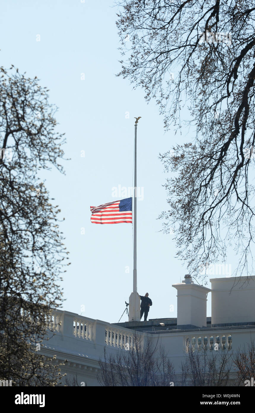 The American flag atop the White House is lowered to half-staff by officials to honor the former ...