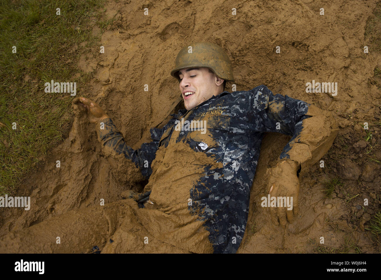 A plebe crawls through a muddy trench during Sea Trials at the United ...