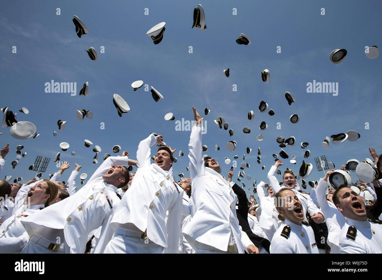 Graduating Midshipmen throw their hats into the air at the end of the ...