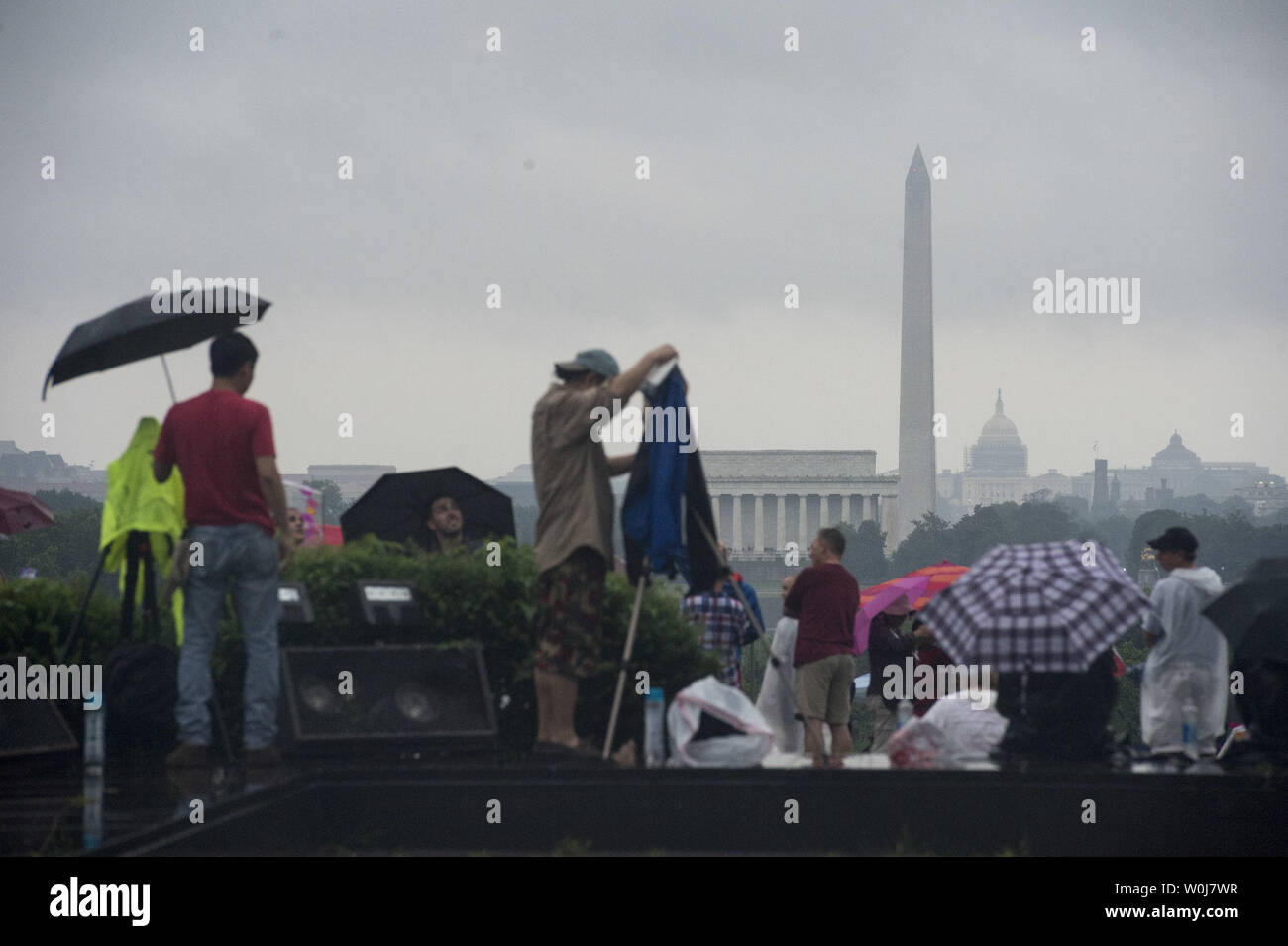 Spectators set up as heavy rains stop prior to the 4th of July firework ...