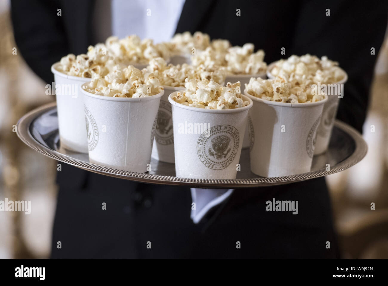 An usher holds a tray of popcorn at a screening of "We Will Rise ...