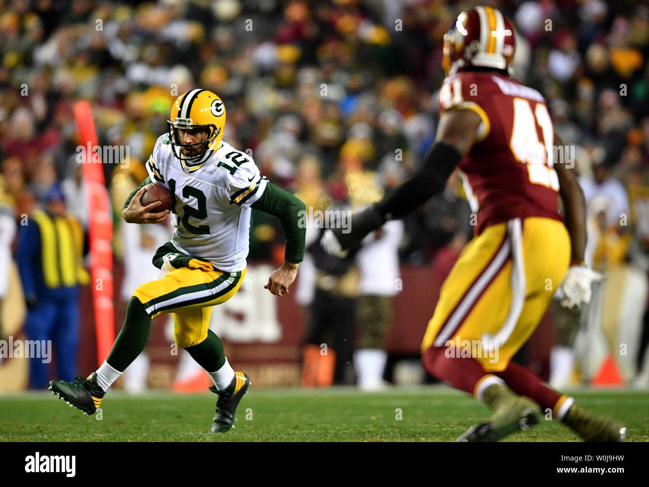 Green Bay Packers quarterback Aaron Rodgers (12) scrambles against the ...