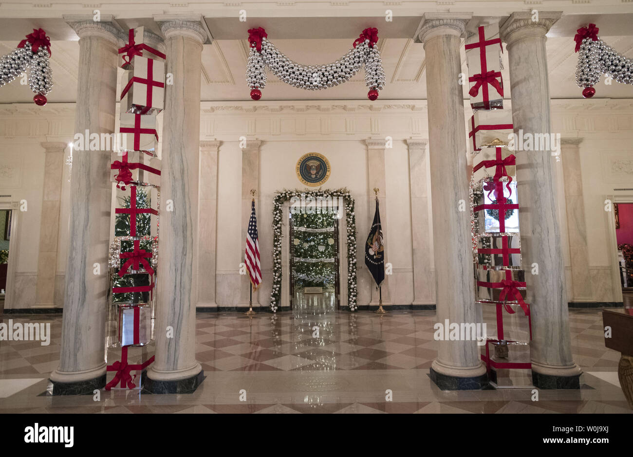 Holiday decorations are seen in the cross hall of the White House in ...