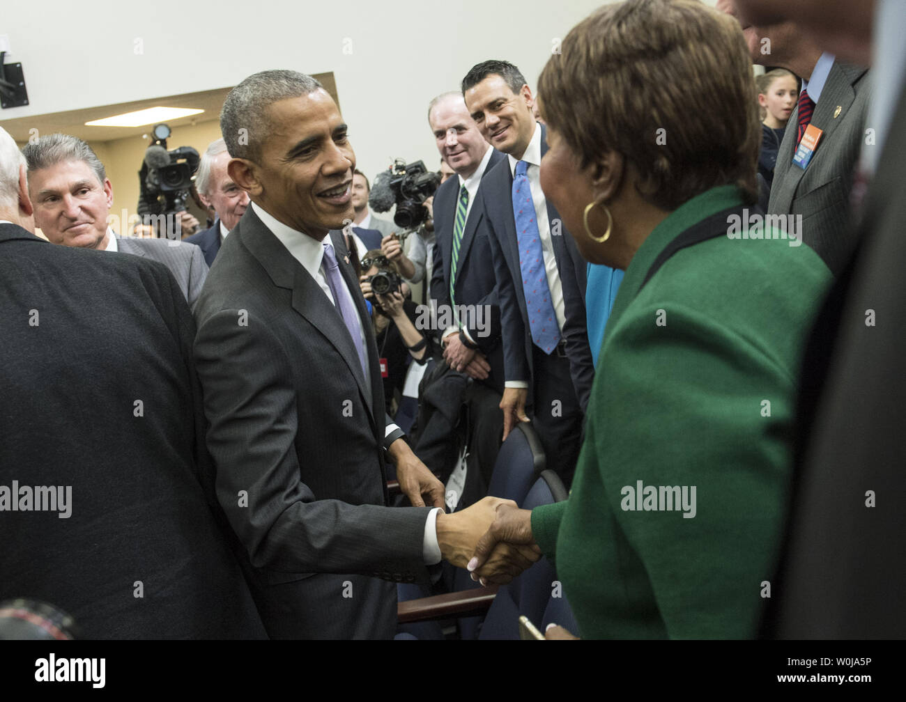 President Barack Obama greets members of congress after signing the ...