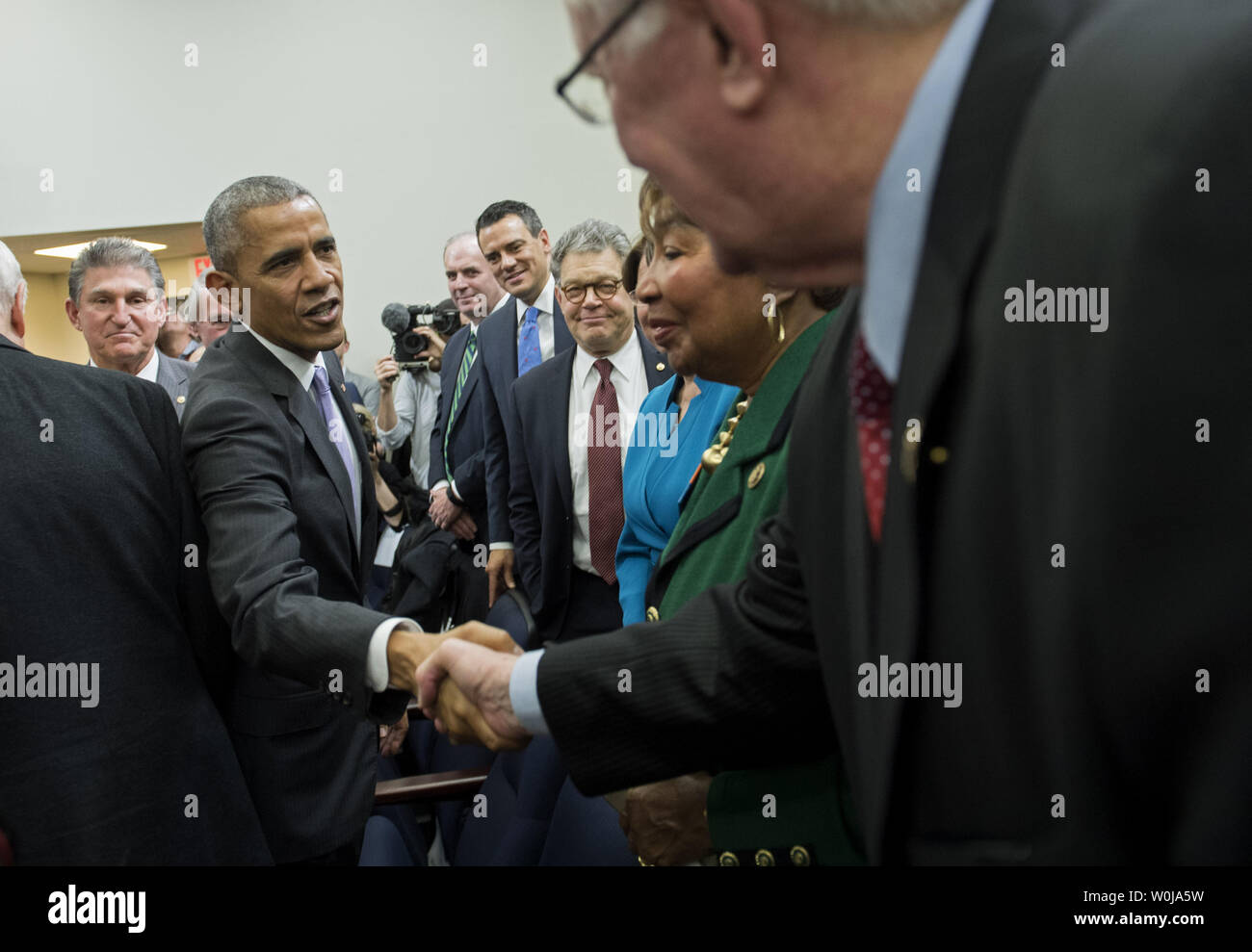 President Barack Obama greets members of congress after signing the ...