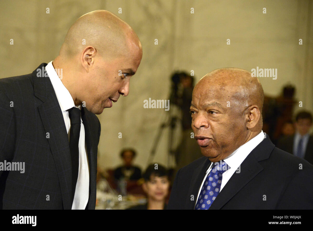 Sen. Cory Booker (L) chats with Rep. John Lewis prior to appearing ...