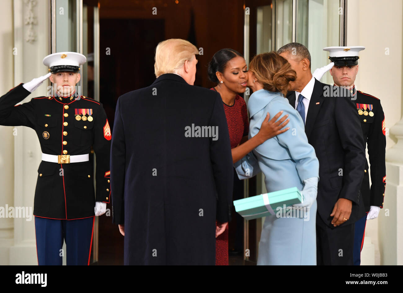 President Barack Obama (R) and Michelle Obama greet President-elect ...