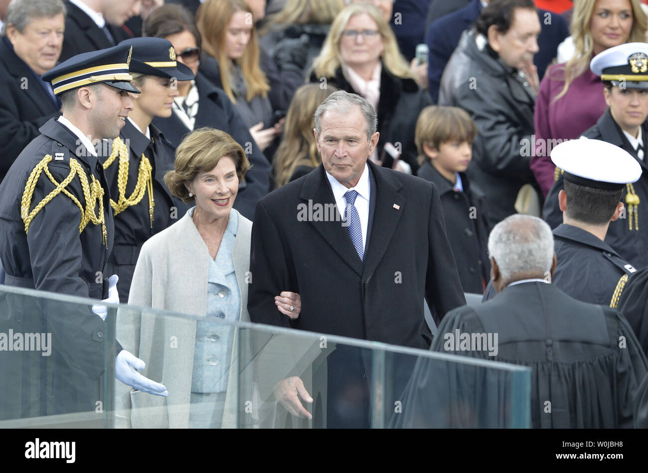 Former President George Bush and wife Laura arrive for the inauguration ...