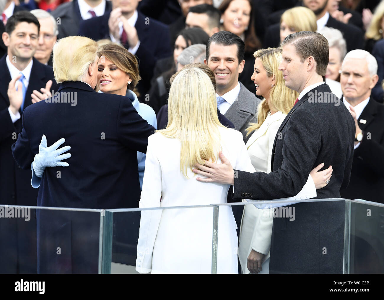 President Donald Trump (L) hugs his wife Melania at the inauguration ...
