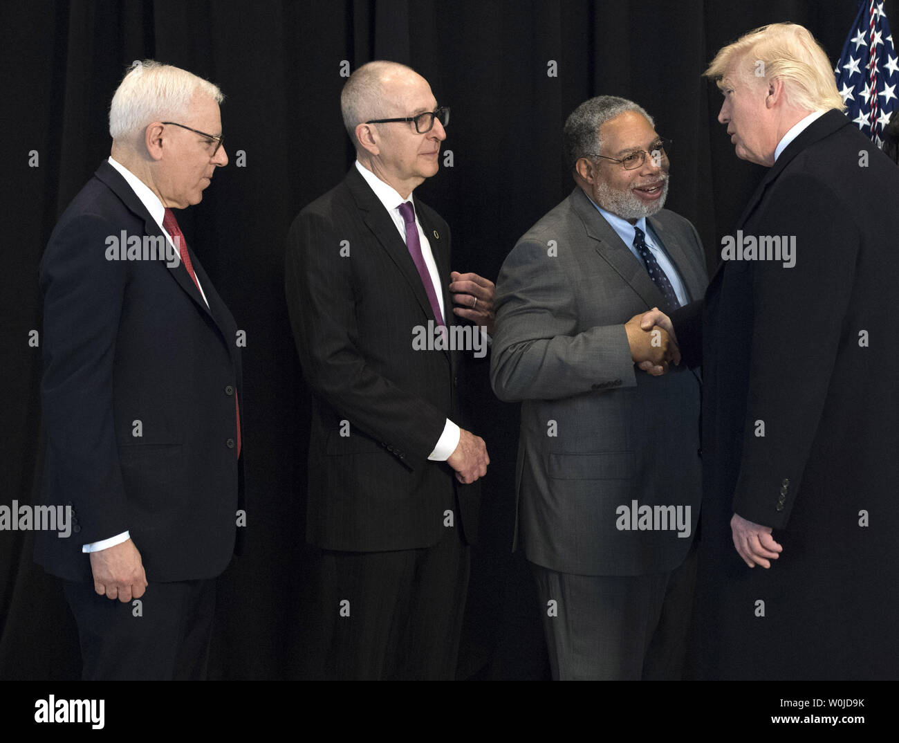 President Donald Trump shakes hands with Lonnie Bunch, founding ...