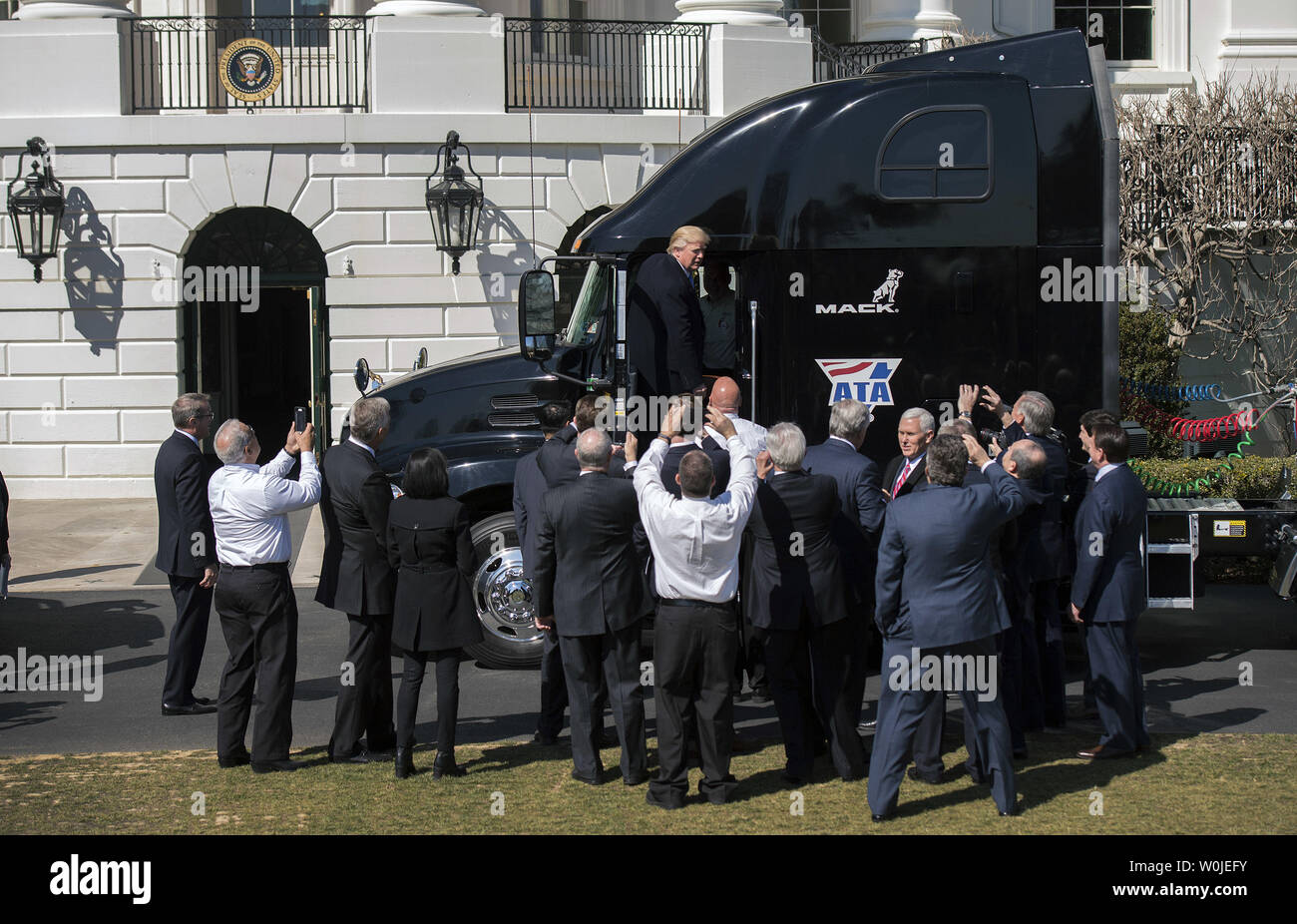 President Donald Trump climbs onto an 18-wheeler truck as he greets ...