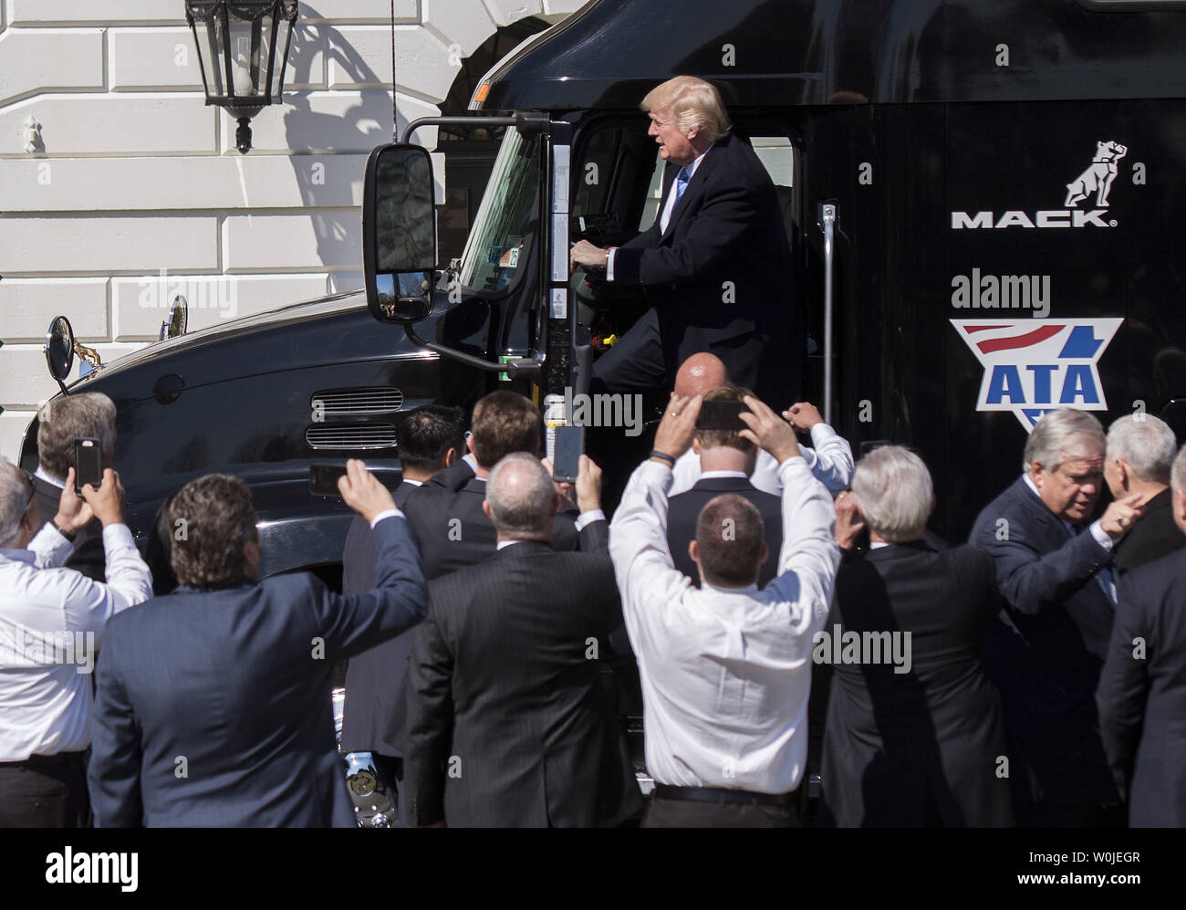 President Donald Trump climbs onto an 18-wheeler truck as he greets ...