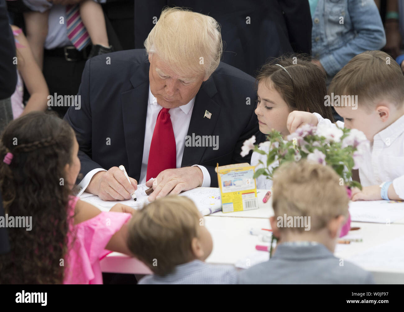 President Donald Trump makes a card for a deployed solder during the ...
