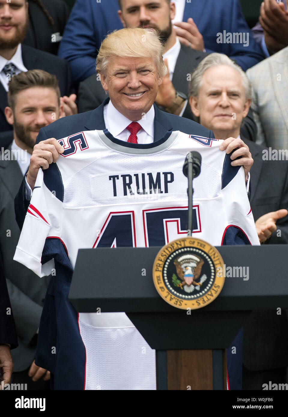 President Donald Trump holds up a custom jersey given to him by New ...