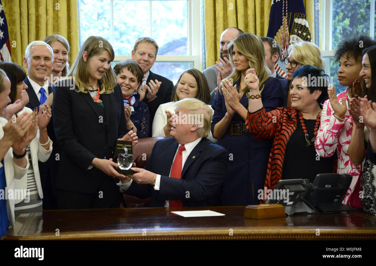 President Donald Trump presents a trophy to The National Teacher of the ...
