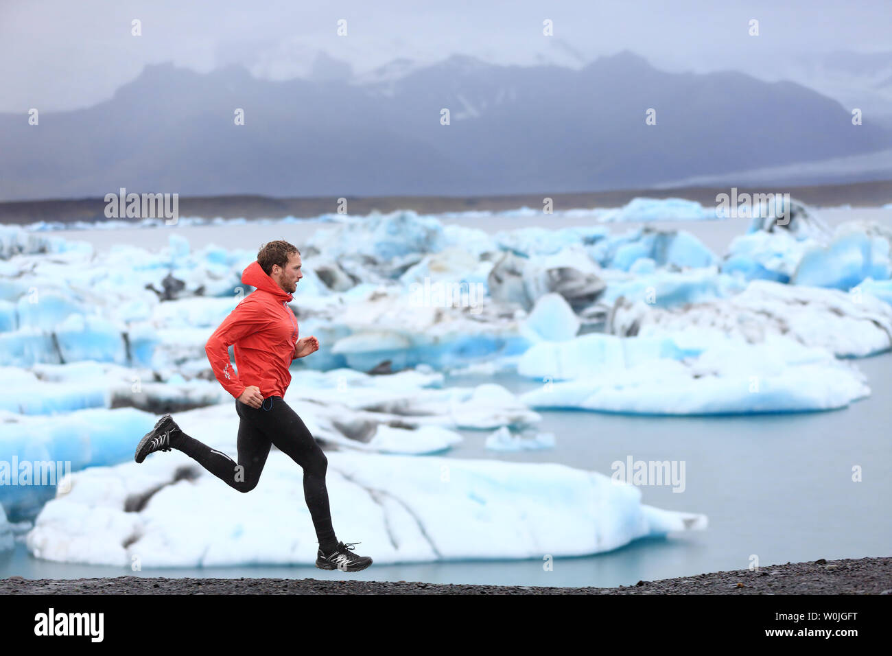 Running man. Sprinting trail runner in fast sprint in beautiful nature ...